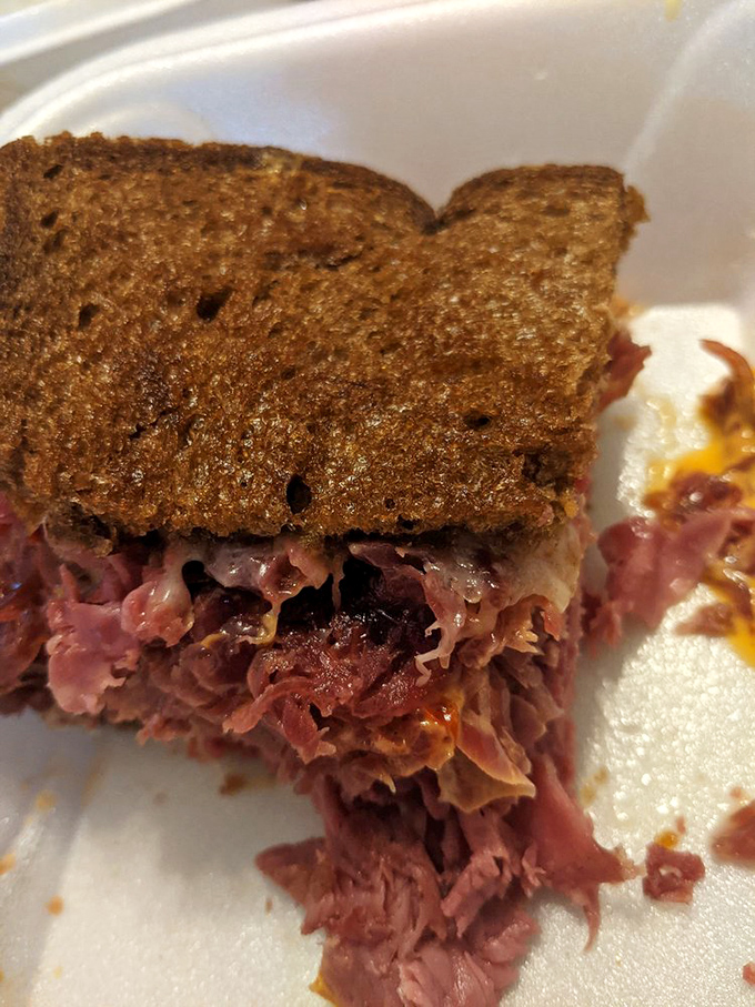 This isn't just a sandwich; it's architecture. Look at those perfectly engineered layers of corned beef, a masterpiece on rye.