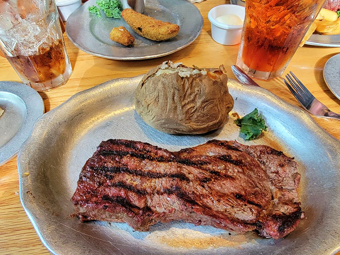This ribeye's grill marks deserve their own Instagram account. The baked potato stands by, knowing it's playing second fiddle to the star.