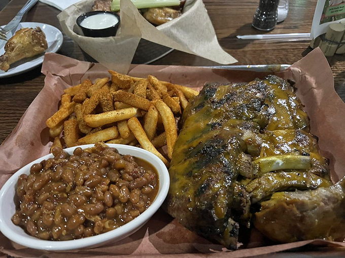 The holy trinity of comfort: perfectly glazed ribs, golden fries, and beans that have clearly been simmering since the dawn of deliciousness.