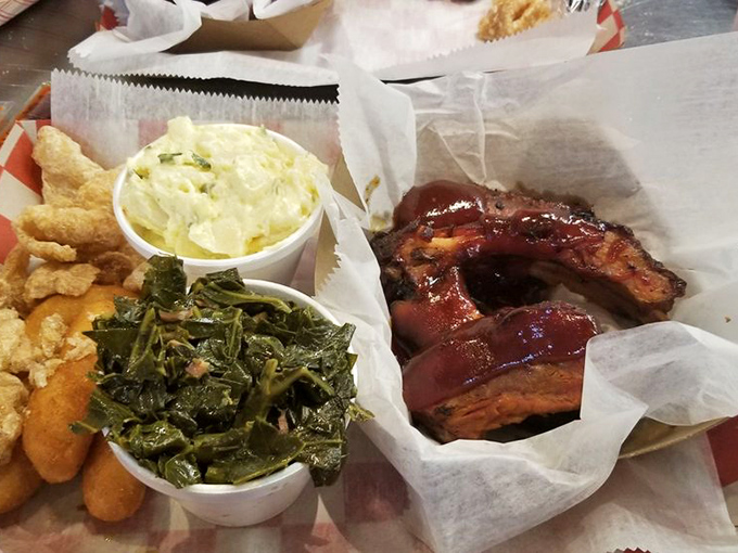 The holy trinity of Southern comfort: ribs glazed with tangy sauce, collards cooked to silky perfection, and hush puppies that crunch like happiness itself.