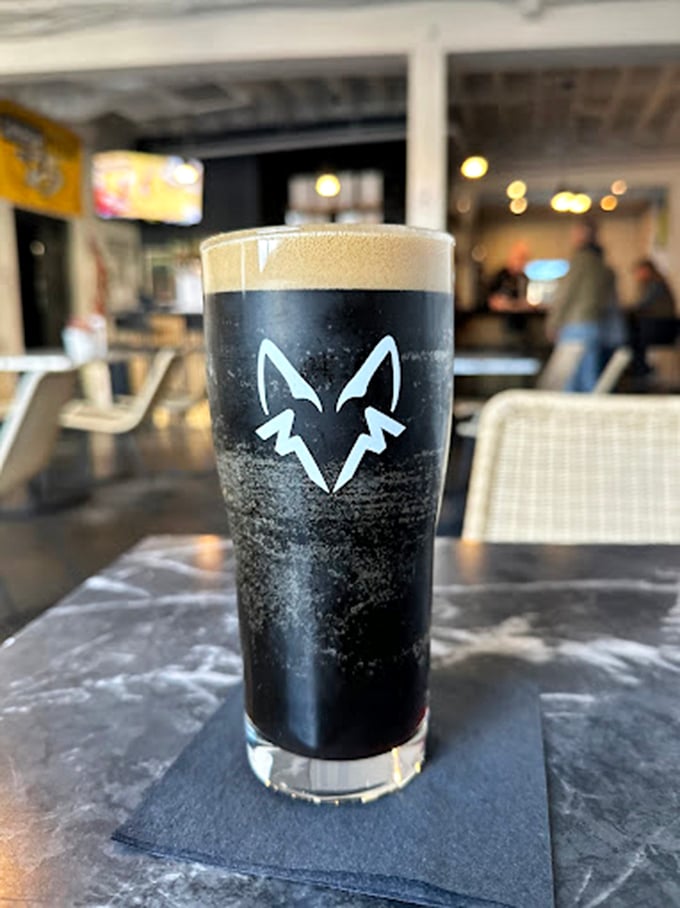 A perfect pour of darkness capped with creamy foam, sporting the brewery's clever fox logo—a glass of midnight that drinks like velvet.