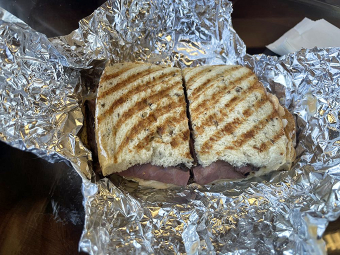 This isn't just a sandwich; it's architecture. Layers of meat and cheese pressed between perfectly grilled bread create the kind of harmony that makes Mozart seem amateur.