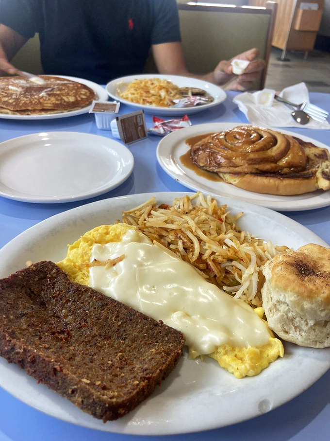 The holy trinity of breakfast: perfectly cooked eggs, crispy hash browns, and that legendary scrapple. Add a biscuit and call it heaven.