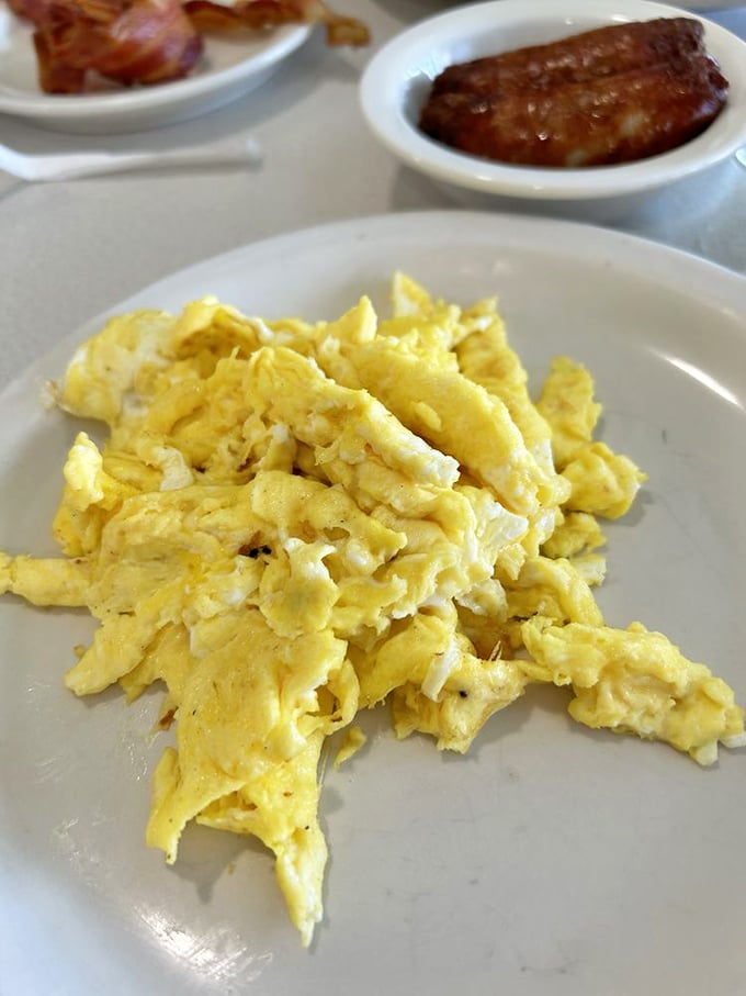 These scrambled eggs aren't just cooked&mdash;they're pampered, fluffed, and served alongside sausage that had serious career goals. 