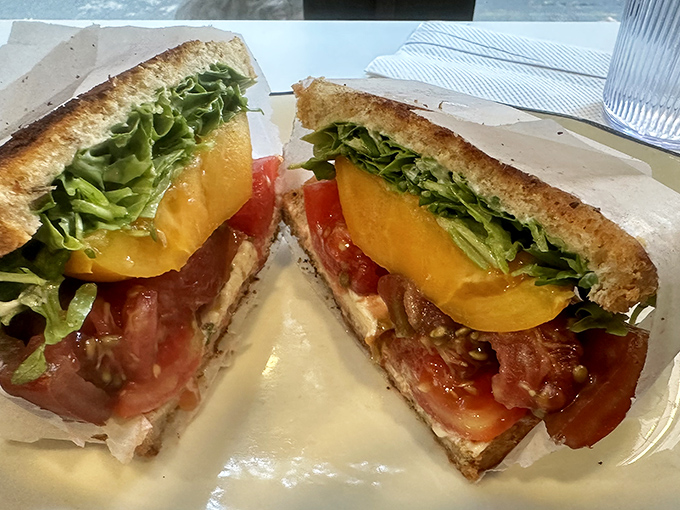 The So Long Sal BLT showcases summer's bounty with tomatoes so vibrant they practically sing between crisp bacon and fresh greens. 