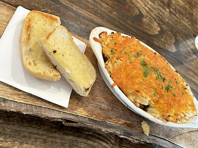The perfect bite: crusty bread for sopping up every last morsel of that Shepherd's Pie gravy that's rich enough to have its own offshore bank account.