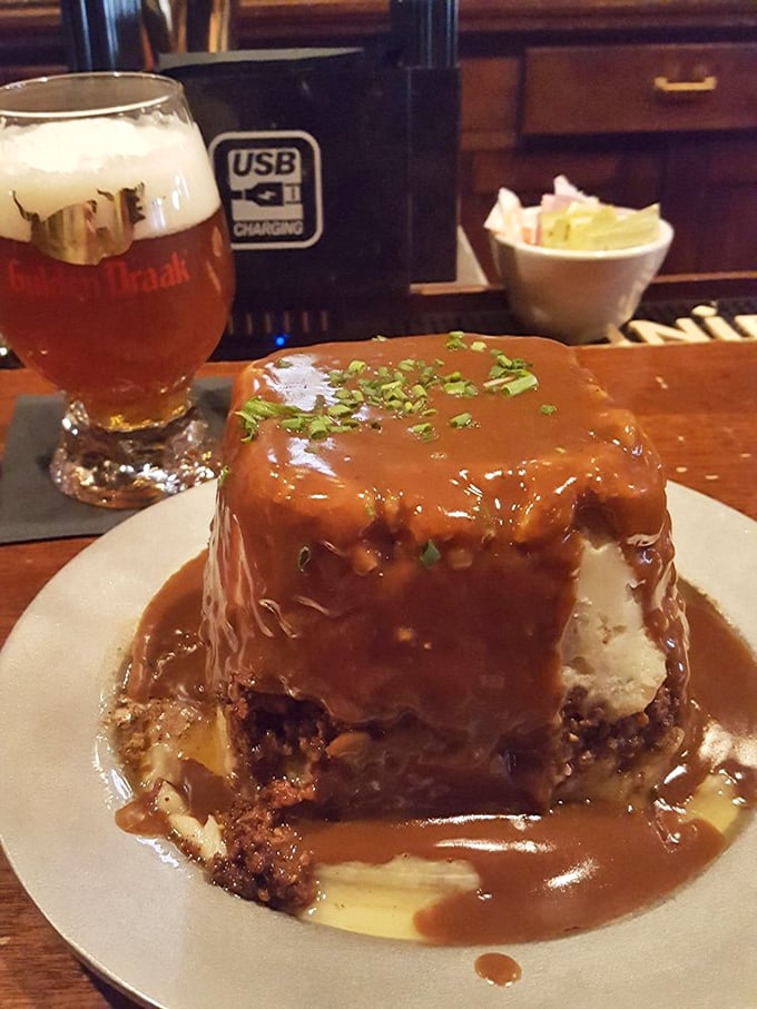 Architecture of flavor: layers of seasoned meat, vegetables, and gravy support a towering summit of mashed potatoes. Comfort food engineering at its finest.