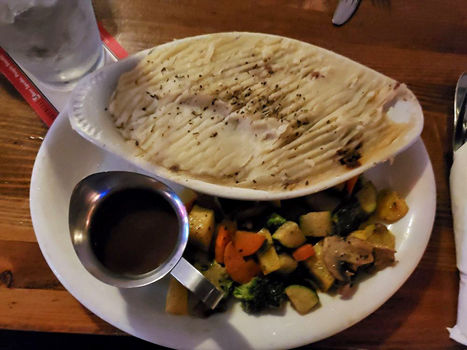 Breaking through that potato ceiling reveals a steamy treasure of seasoned meat and gravy&mdash;comfort food archaeology at its finest.