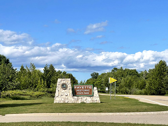 The entrance sign stands like a promise &ndash; beyond this point, the modern world fades and a journey through Michigan's industrial past begins.