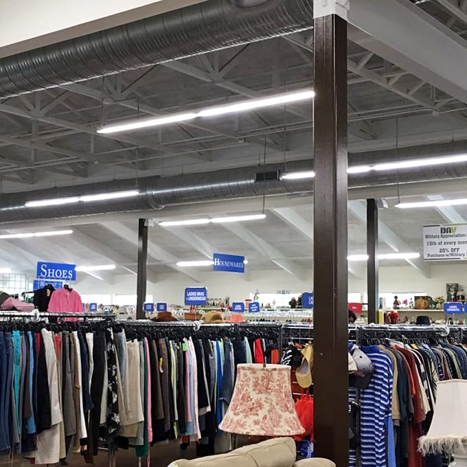 Department signs float above a sea of merchandise like friendly buoys, helping bargain hunters navigate this ocean of second-hand treasures.