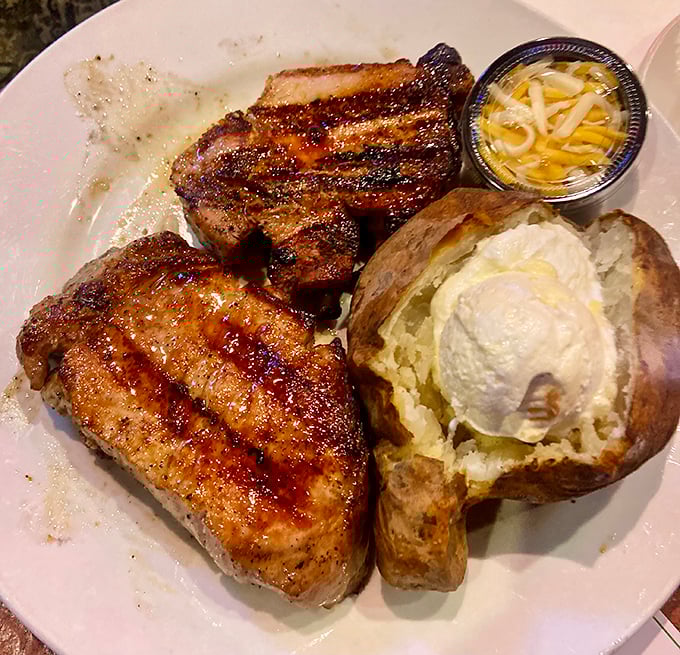 Two perfectly grilled pork chops flanking a loaded baked potato&mdash;a trio that performs better than The Three Tenors ever did.