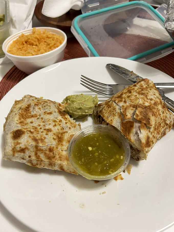 The kind of burrito that makes you reconsider your relationship with other foods. Note the essential trinity: green salsa, guacamole, and Spanish rice.
