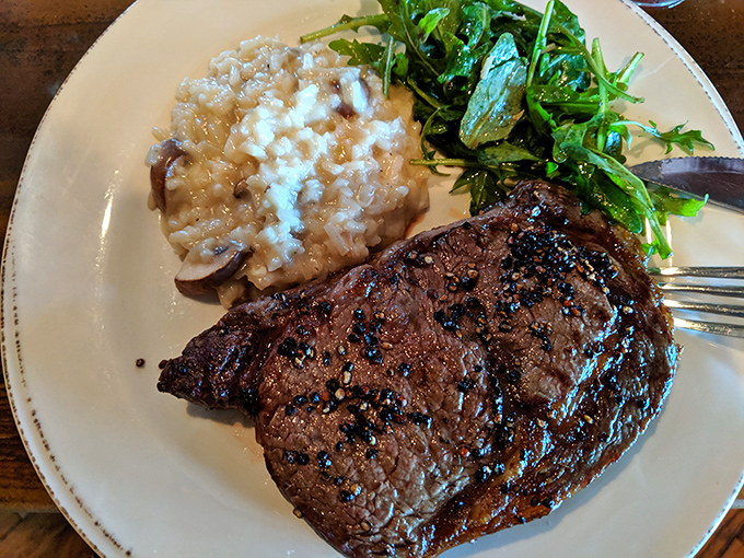 A masterclass in simplicity: perfectly cooked steak alongside creamy risotto and fresh greens&mdash;proof that three perfect elements need nothing else.