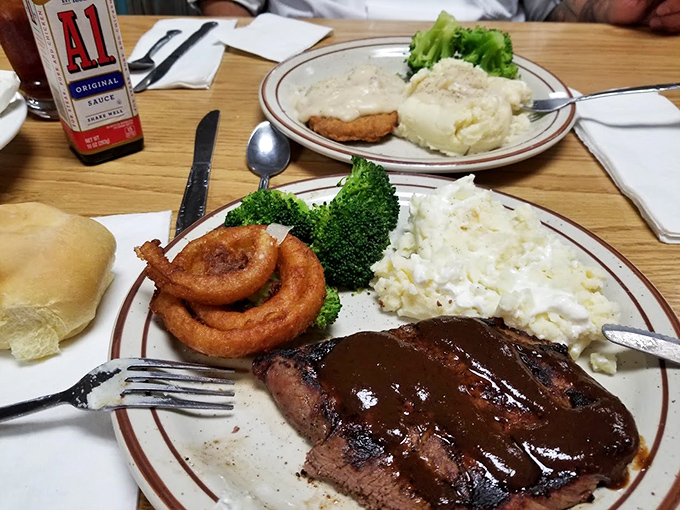 Steak with a side of onion rings and that glossy sauce &ndash; proof that happiness doesn't always need complexity, just quality ingredients and proper execution.