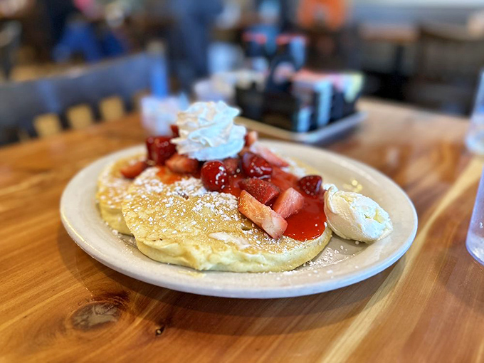These strawberry pancakes aren't just breakfast, they're dessert with an alibi &ndash; complete with whipped cream islands floating in a berry sea.