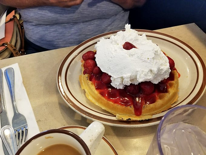 Strawberries and cream atop a golden waffle&mdash;nature's perfect partnership, like Packers fans and cheese hats, but infinitely more delicious.