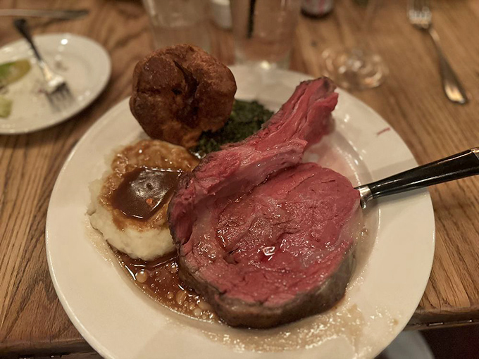 Behold the Tam Cut in all its glory – a thick, succulent slab of perfectly roasted prime rib accompanied by creamy mashed potatoes and Yorkshire pudding.