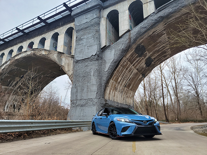 The bridge's weathered underbelly reveals patches and repairs, each mark telling a story like wrinkles on an elder's face&mdash;history written in concrete.