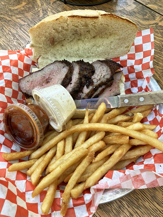 The tri-tip sandwich arrives with its faithful sidekick&mdash;golden fries&mdash;and two dipping sauces that deserve their own fan club.
