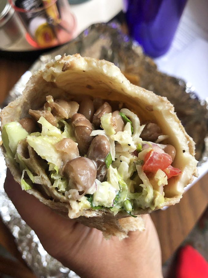 Peek inside this veggie masterpiece and discover the secret to happiness: perfectly balanced beans, lettuce, and all the fixings in harmonious coexistence.