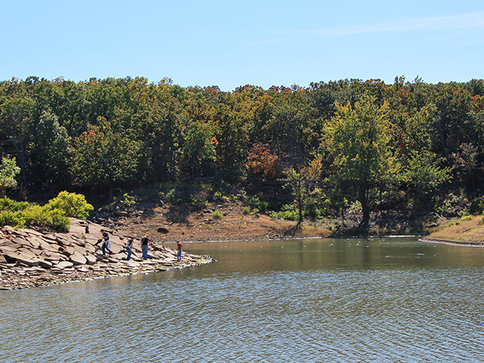 Amateur geologists at work! These shoreline explorers aren't just walking—they're time-traveling through millions of years of Kansas geological history.