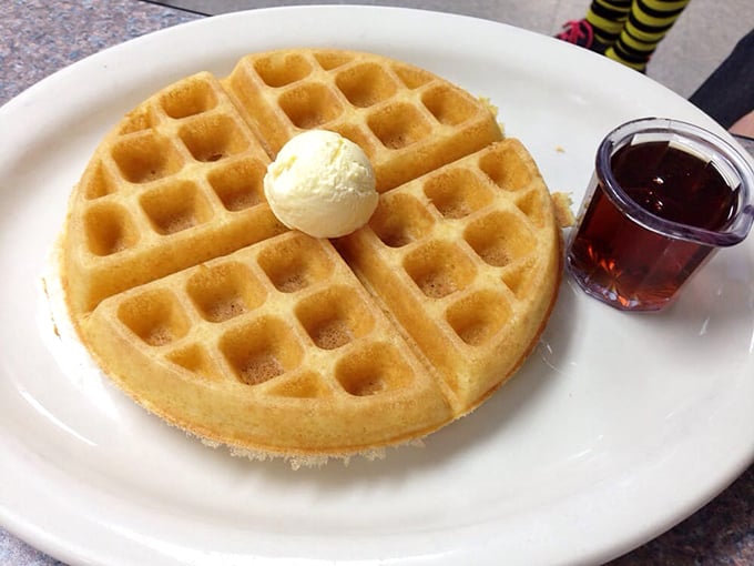 Simplicity perfected: a golden Belgian waffle with a dollop of butter and syrup on standby. Some mornings don't need complications, just carbs done right.