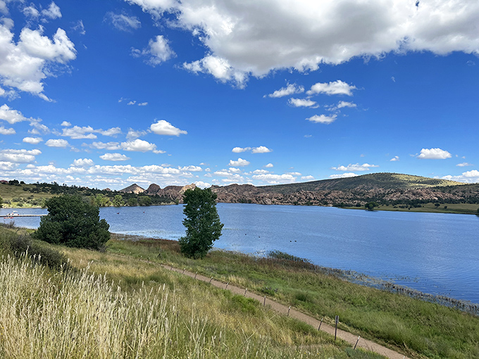 Watson Lake's serene waters reflect the surrounding hills like nature's own Instagram filter. No photoshop required for this postcard-perfect scene.