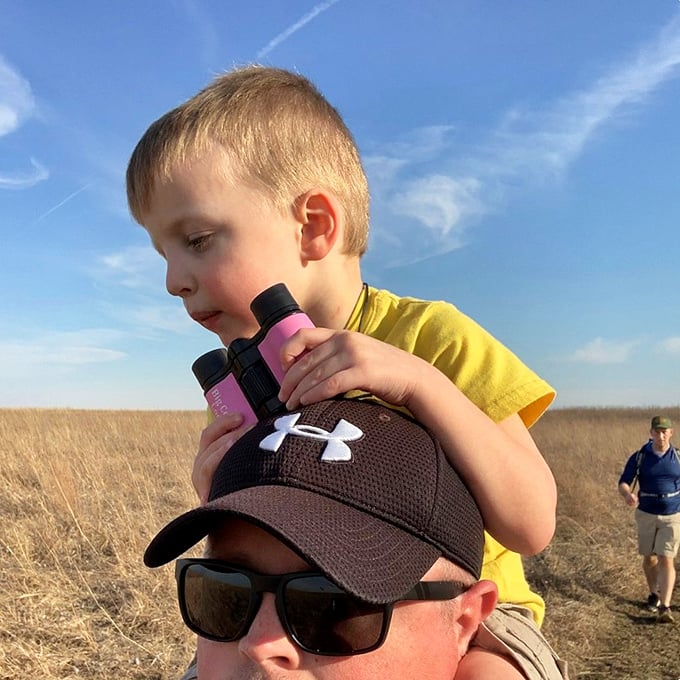 The next generation of naturalists getting a shoulder-top view. Sometimes the best wildlife spotting happens when you're the tallest one in the group.