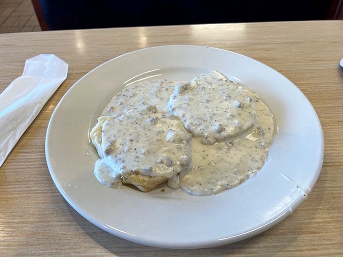 Behold the biscuits and gravy&mdash;where pepper-speckled white gravy blankets everything like a Southern snowfall that actually makes people happy.