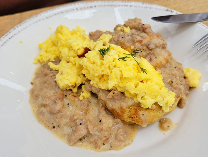 Breakfast alchemy at its finest&mdash;creamy gravy cascading over a fresh biscuit with fluffy scrambled eggs playing the perfect supporting role.