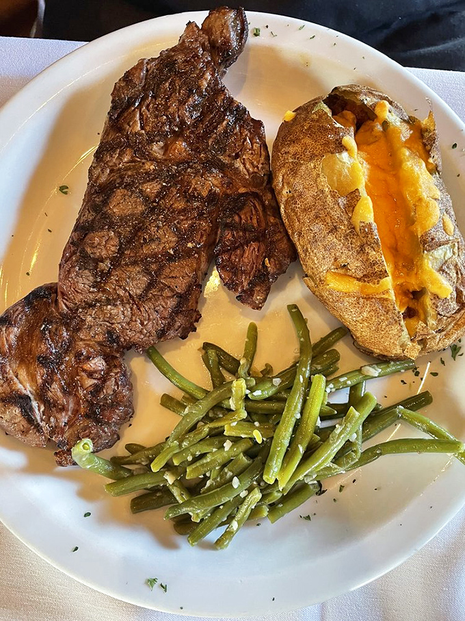 Behold the ribeye in its natural habitat&mdash;gloriously charred exterior, surrounded by sides eager to soak up every last drop of its magnificent juices.