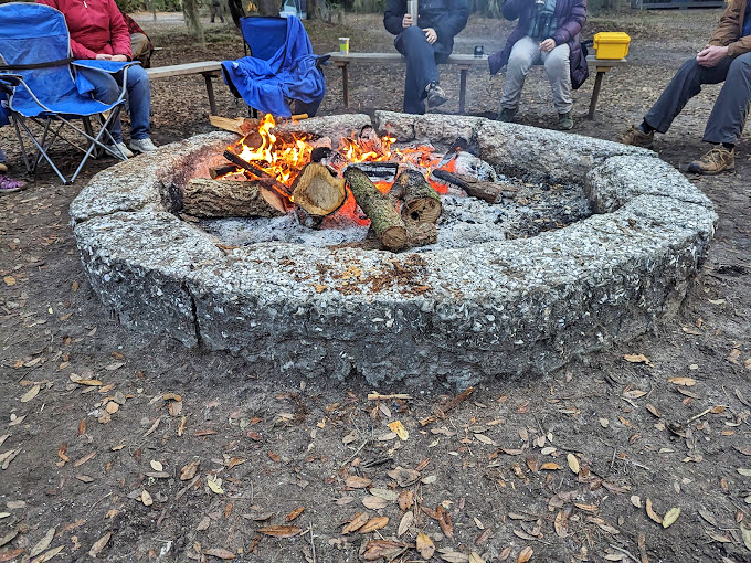 Gathering around a stone fire ring, island visitors transform an ordinary evening into memories that outlast the embers.