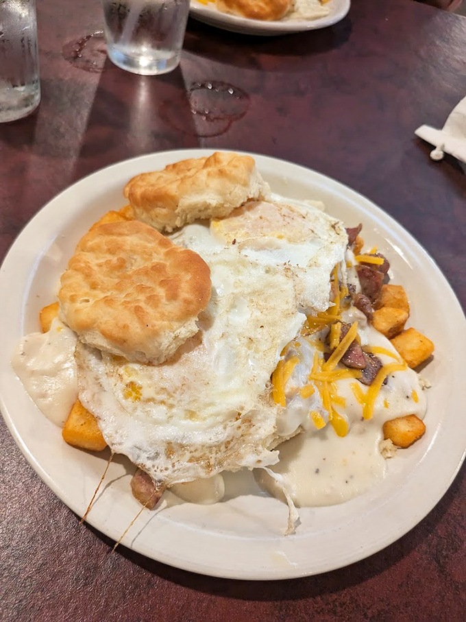 Breakfast architecture at its finest &ndash; eggs, biscuits, and country potatoes stacked with the structural integrity of a Frank Lloyd Wright design.