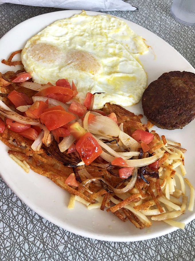 Crispy hash browns with the colorful confetti of fresh vegetables, perfectly cooked eggs, and a sausage patty. Breakfast doesn't need to be complicated to be exceptional.