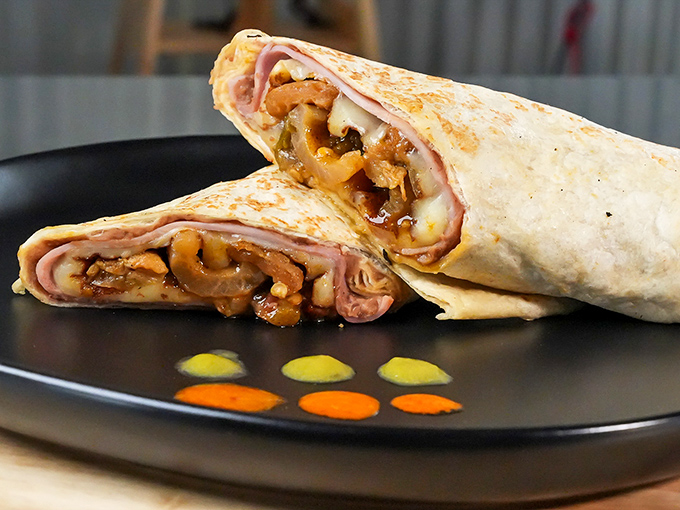 The cross-section reveals the truth: this isn't just a burrito, it's architectural genius. Every ingredient playing its part in perfect harmony, like a delicious orchestra.