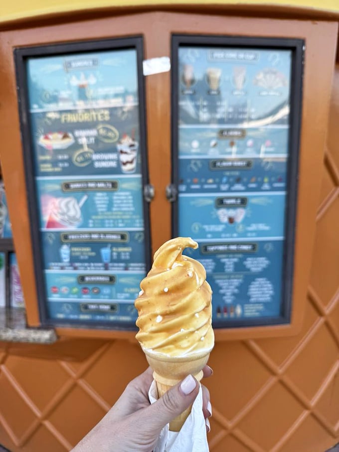 Butterscotch-dipped soft serve: where ice cream meets architecture. That perfect golden shell shatters with each bite, revealing creamy vanilla underneath.
