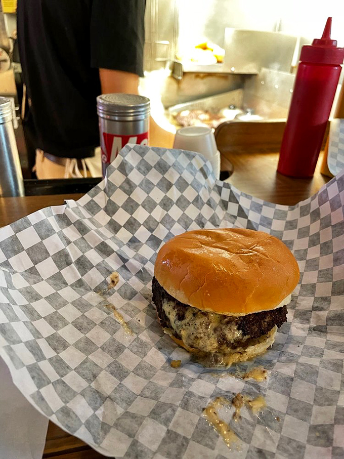 The moment of truth: that first bite reveals the Jucy Lucy's gooey soul, a cheese eruption that's worth every potential chin burn.