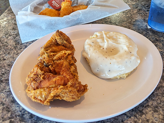The perfect plate: crispy fried chicken alongside creamy mashed potatoes smothered in gravy. Some relationships are complicated; this one is pure harmony.