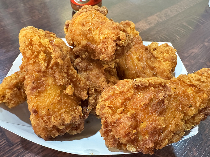 This isn't just fried chicken; it's edible architecture with a golden-brown facade that crackles with each bite, revealing juicy treasures within.