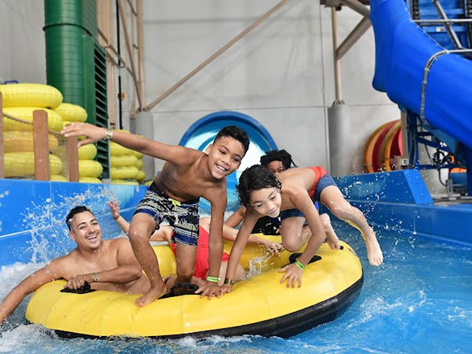 Three kids, one yellow raft, and expressions ranging from "this is awesome" to "I may have made a terrible mistake." Family memories in the making!