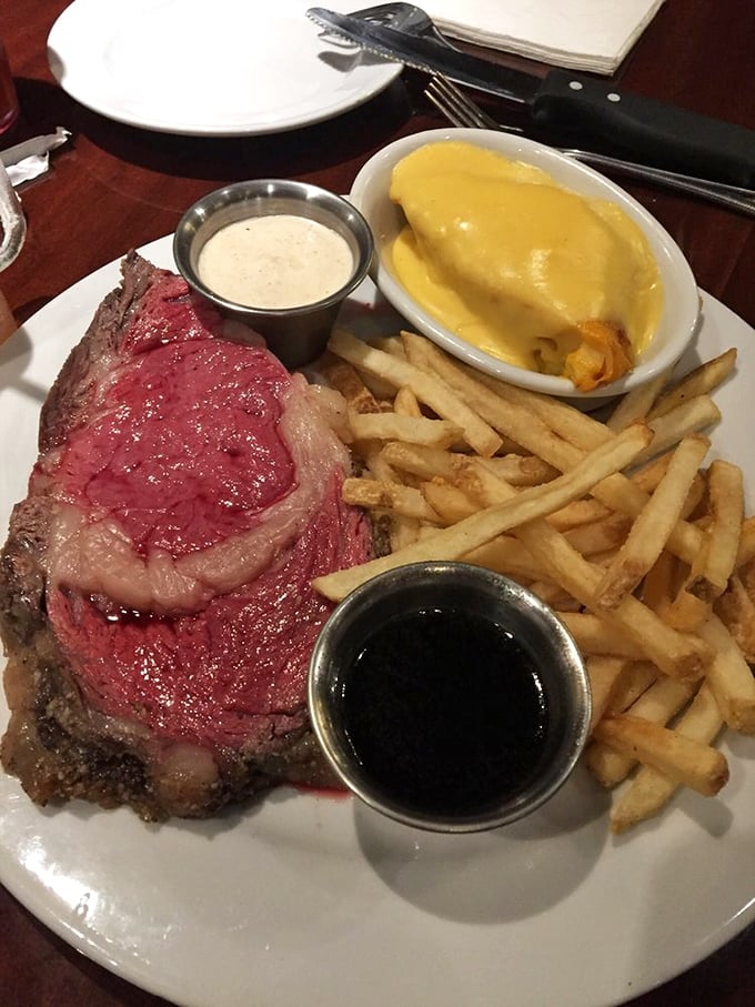 The perfect plate geometry: a thick slice of ruby-red prime rib, golden fries, and mac and cheese that's practically begging for its own Instagram account.