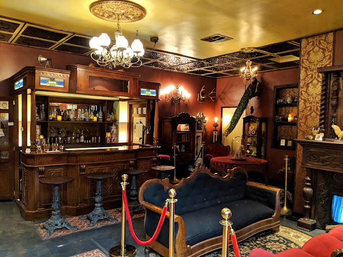 Not your grandmother's living room&mdash;unless your grandmother was Morticia Addams. The vintage bar and velvet settee whisper tales of lavish gothic soir&eacute;es.