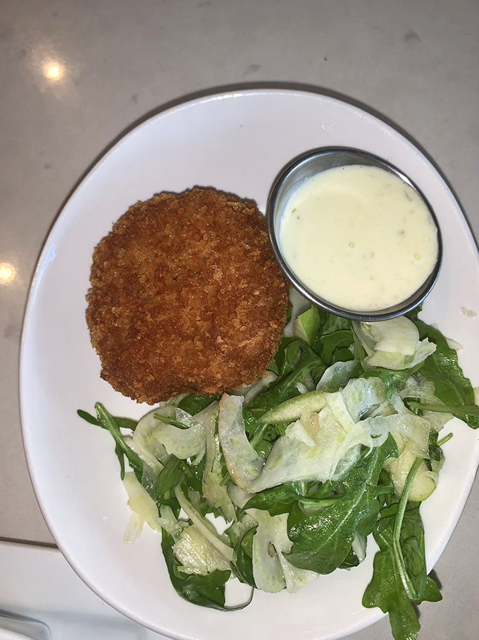 Crab cake perfection served with a crisp, fresh salad and house sauce. This is the plate that launches a thousand road trips.