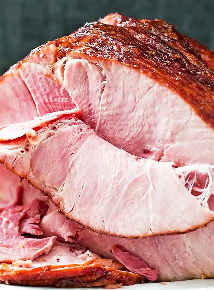 This ham isn't just glazed, it's having its glamour shot. Each slice is a pink masterpiece that would make even vegetarians question their life choices.