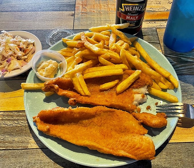 Golden-battered fish resting on a bed of crispy fries&mdash;proof that sometimes the simplest combinations make for the most satisfying meals.