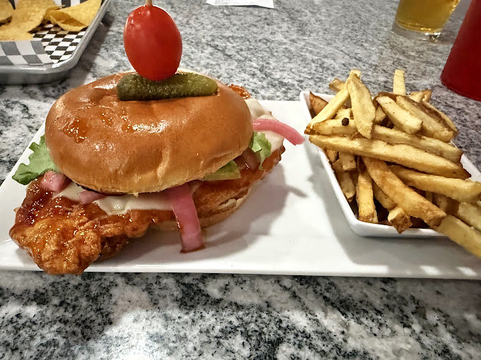 This isn't just lunch, it's an edible work of art—golden-battered fish, pillowy bun, and hand-cut fries that would make any food critic swoon.