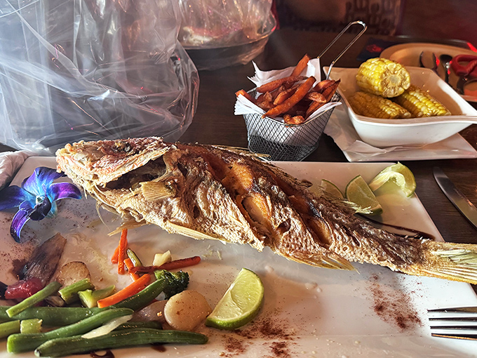 A whole fish that stares back at you is honest dining. This beauty, perfectly bronzed and surrounded by veggies, tells no lies.
