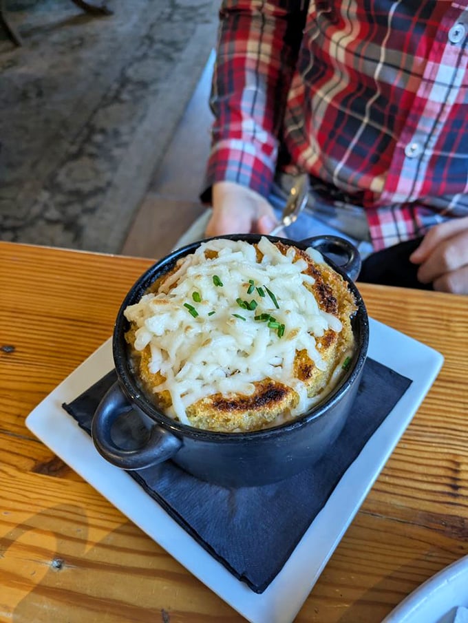 The French onion soup arrives in its own little black cauldron, like a witch's potion that casts a spell of pure contentment.