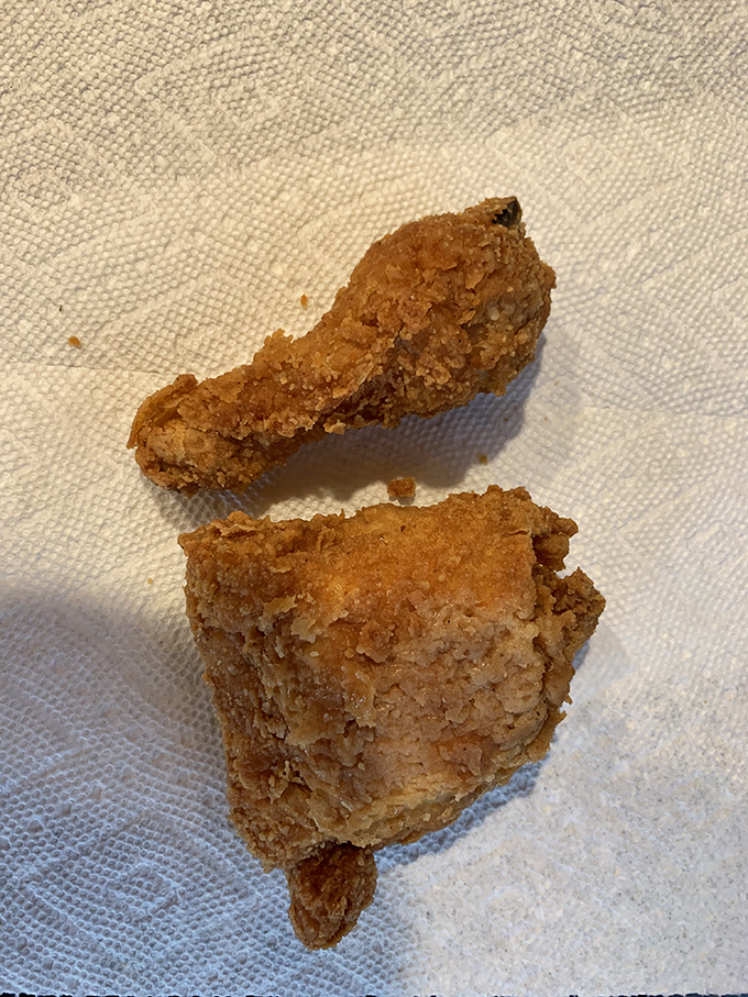 This close-up reveals the secret to great fried chicken: a crust with character, seasoned to perfection, protecting juicy meat within.