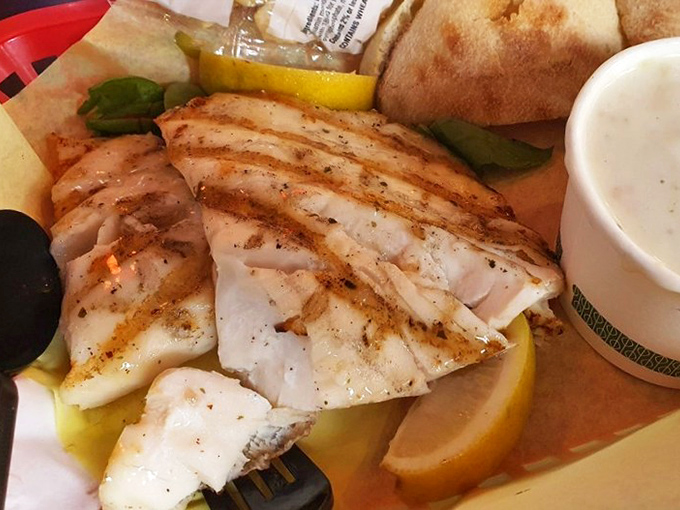 The grilled fish doesn't just flake—it practically sings. Perfectly seasoned and kissed by flame, this plate proves simplicity is the ultimate sophistication in seafood preparation.